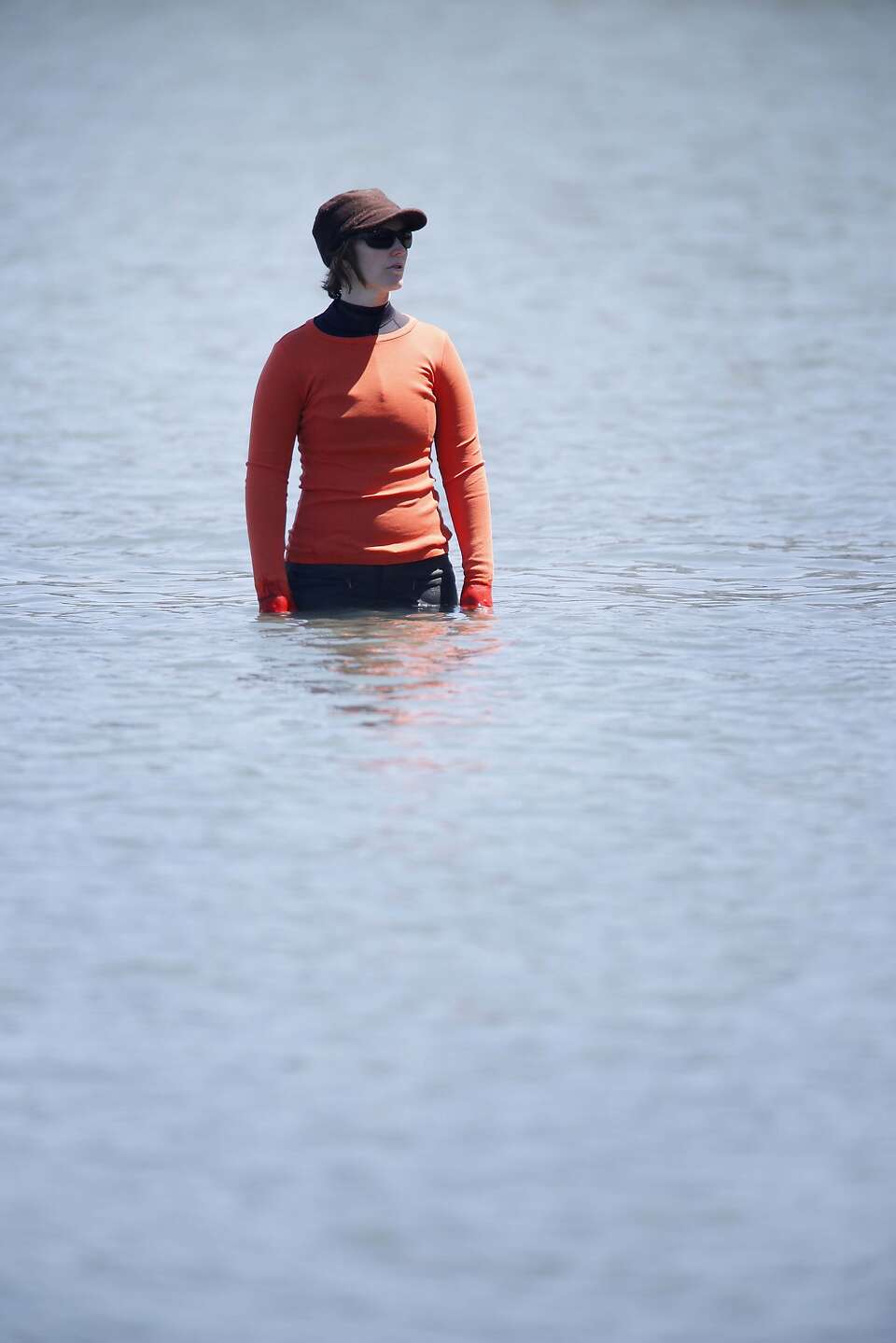 Artist stands in bay to turn tide against global warming