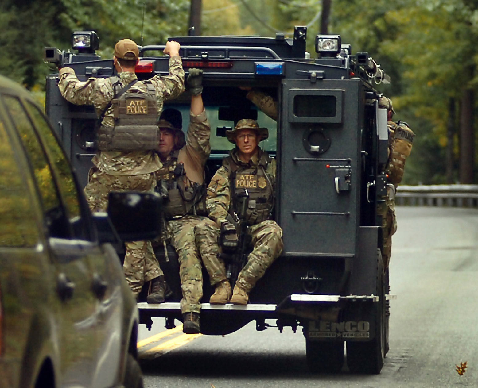 Tense hunt in trooper ambush case hits 8 days