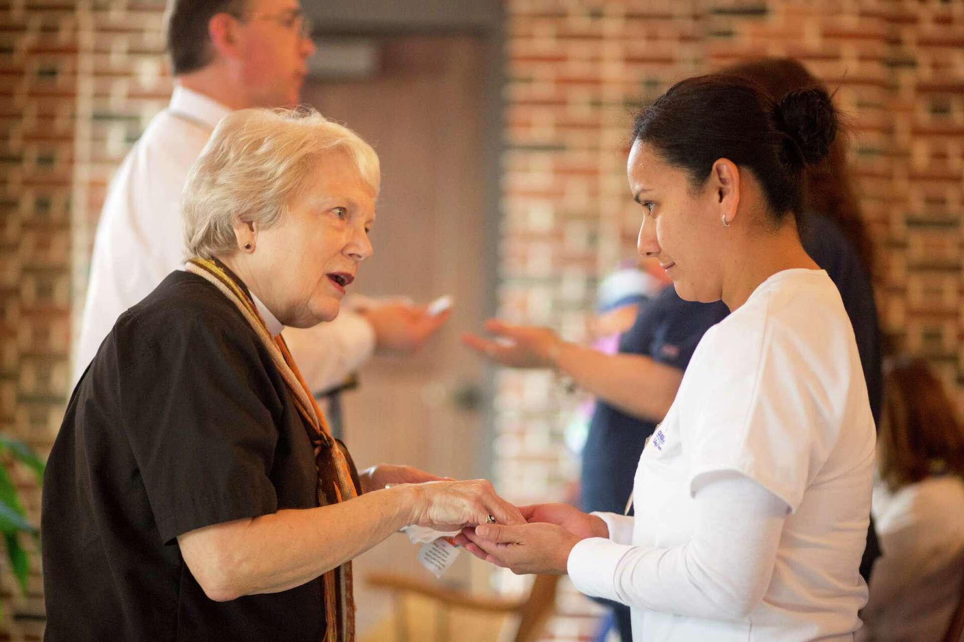 Hands of hospice workers blessed in prayerful ceremony