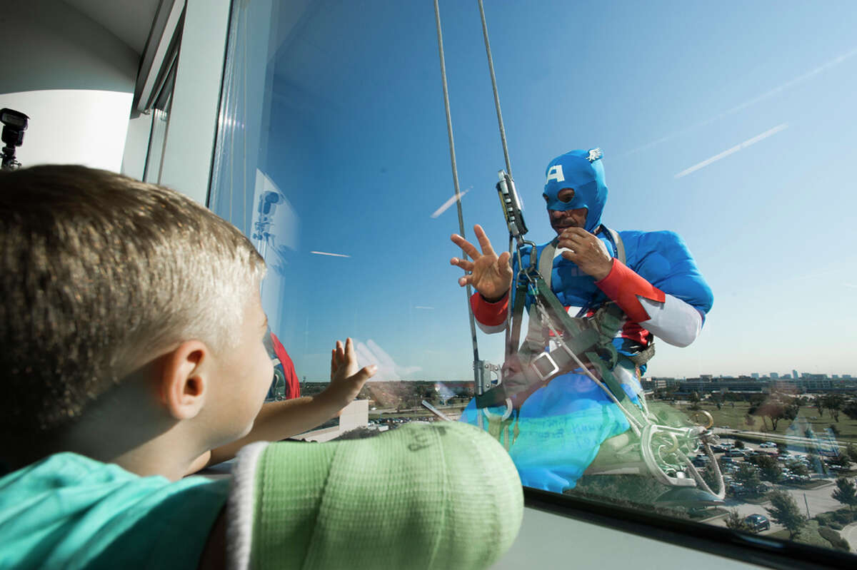 Window washers dressed as superheroes give kids at Texas Children's ...
