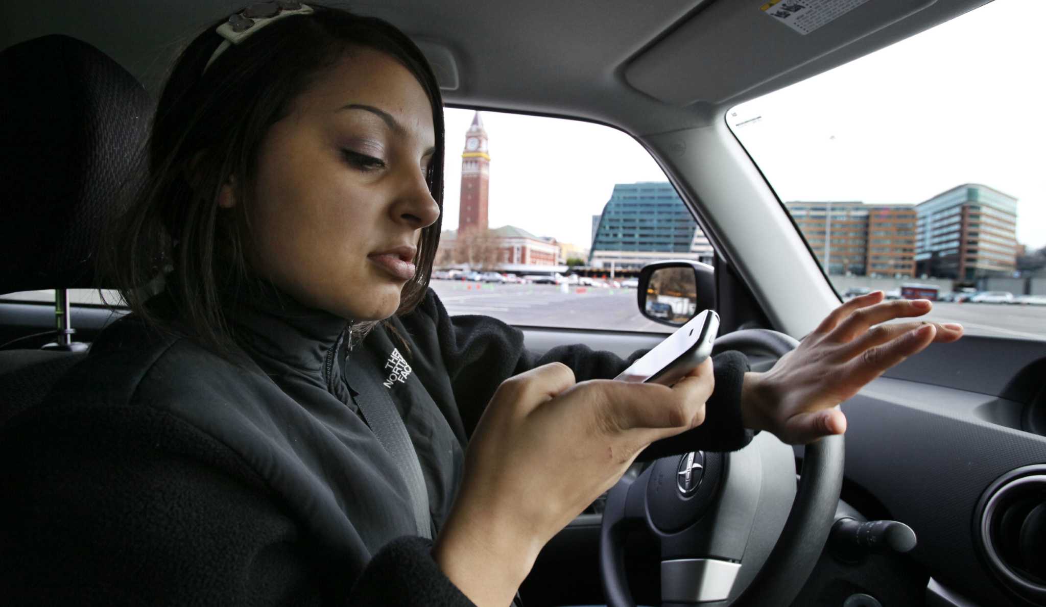 Council passes ban on handheld devices while driving