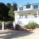 Covered veranda with bay views highlights Cape Cod-style home in ...