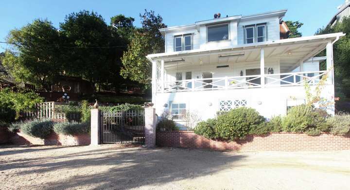 Covered veranda with bay views highlights Cape Cod-style home in Sausalito