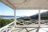 Covered veranda with bay views highlights Cape Cod-style home in Sausalito