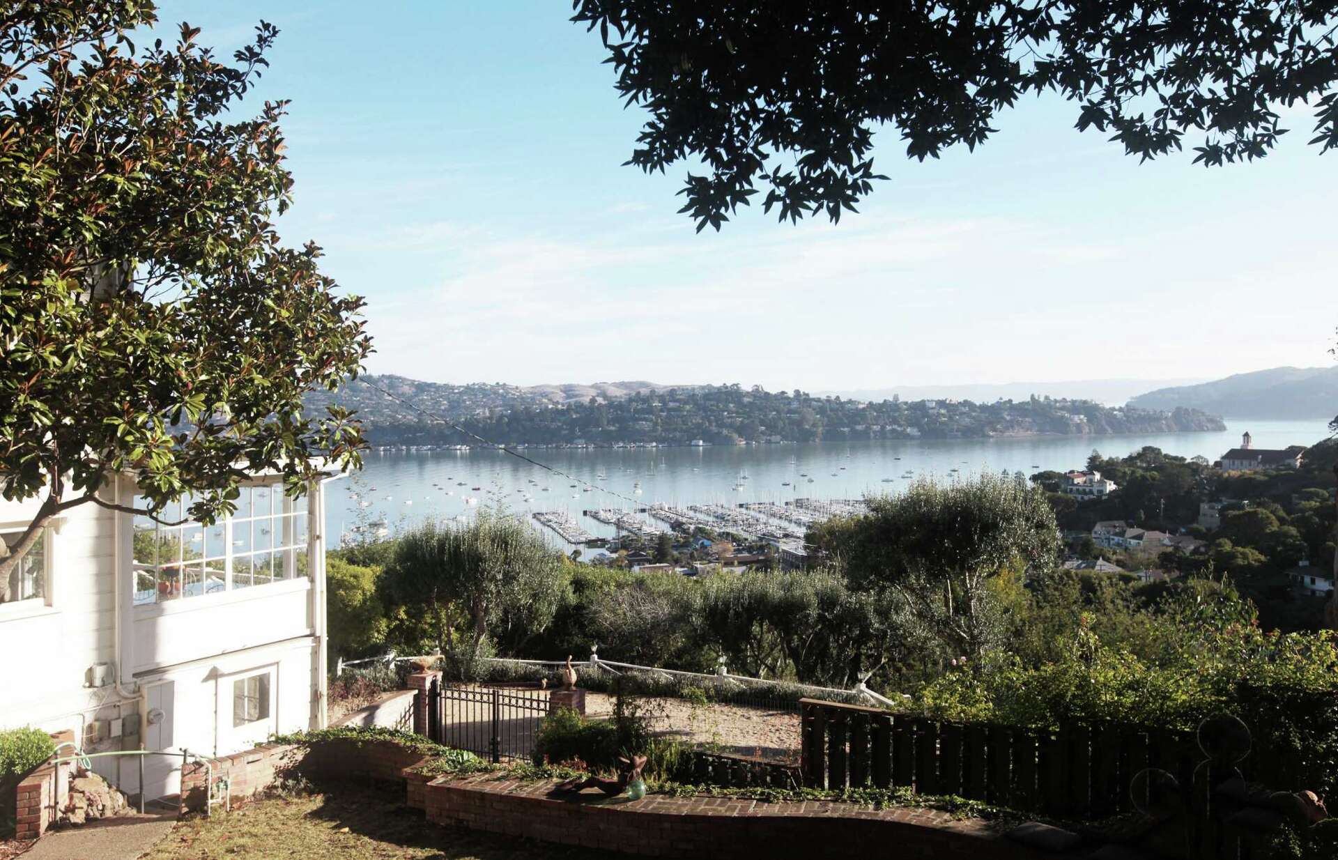 Covered veranda with bay views highlights Cape Cod-style home in Sausalito