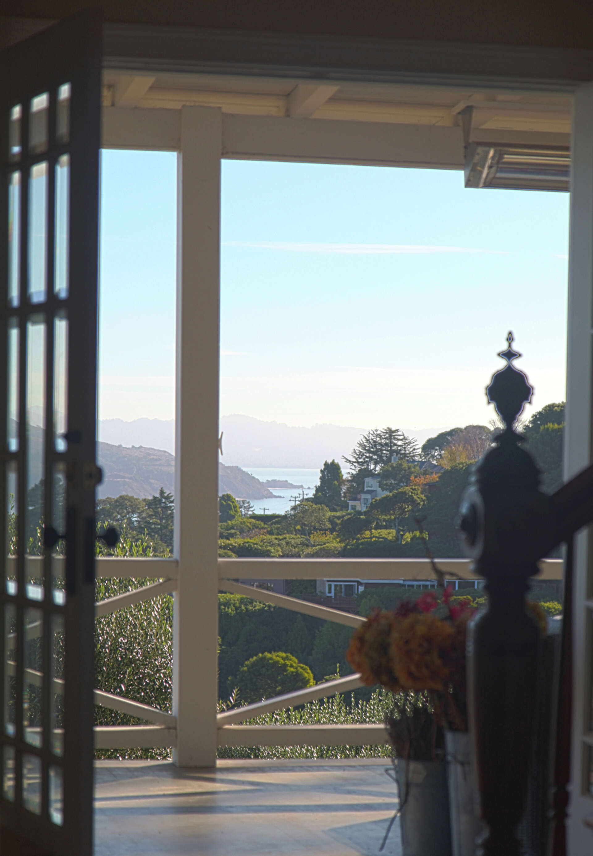 Covered veranda with bay views highlights Cape Cod-style home in Sausalito