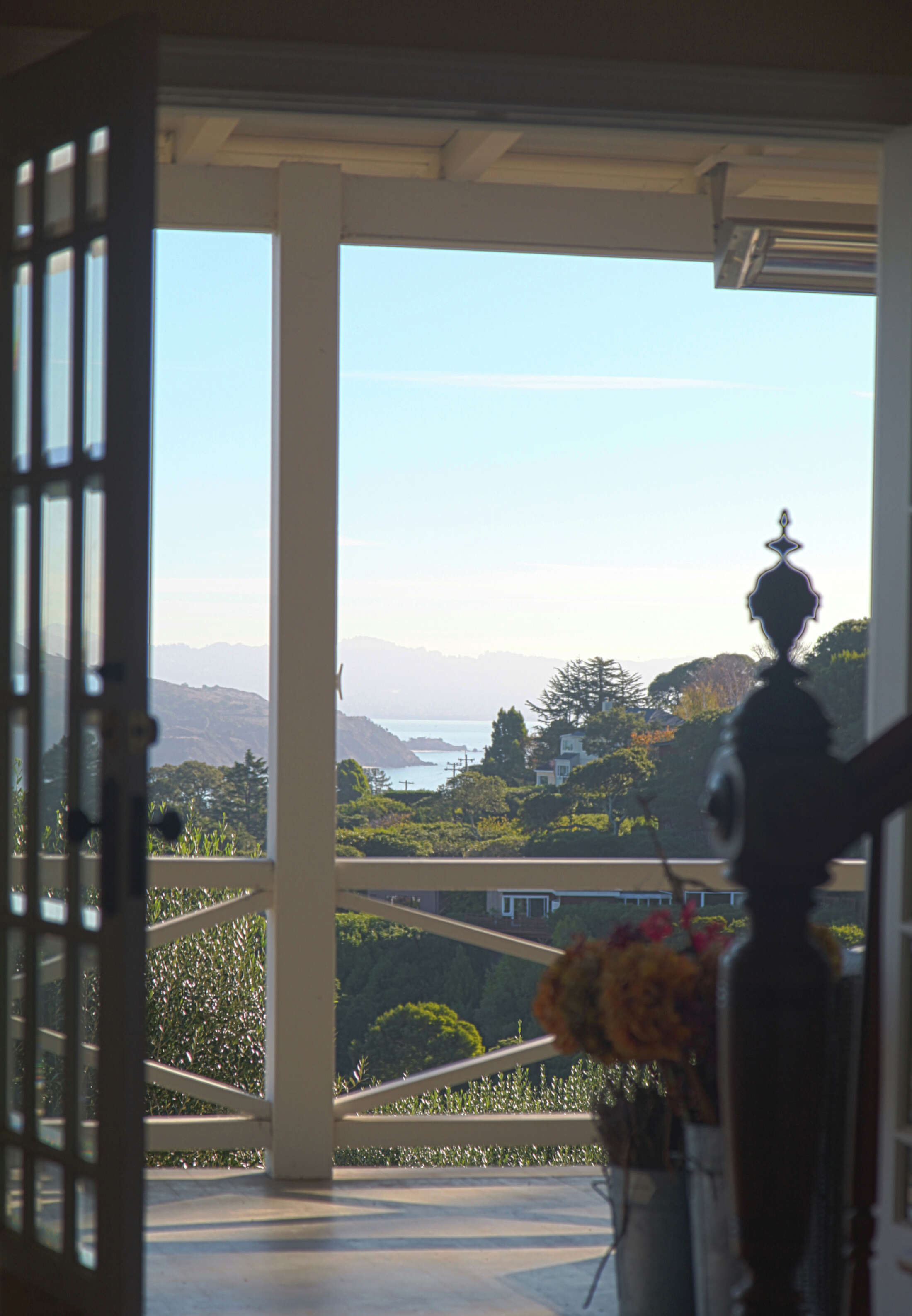 Covered veranda with bay views highlights Cape Cod-style home in Sausalito