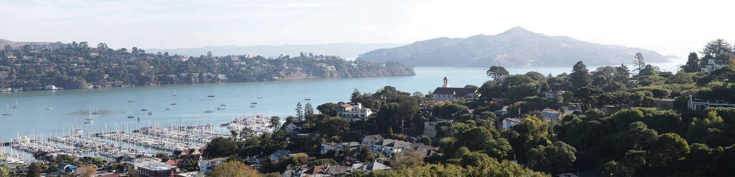 Covered veranda with bay views highlights Cape Cod-style home in Sausalito