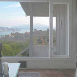 Covered veranda with bay views highlights Cape Cod-style home in ...