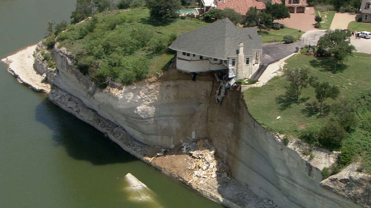 Rain-soaked cliff where burned luxury home once stood falls into Lake ...