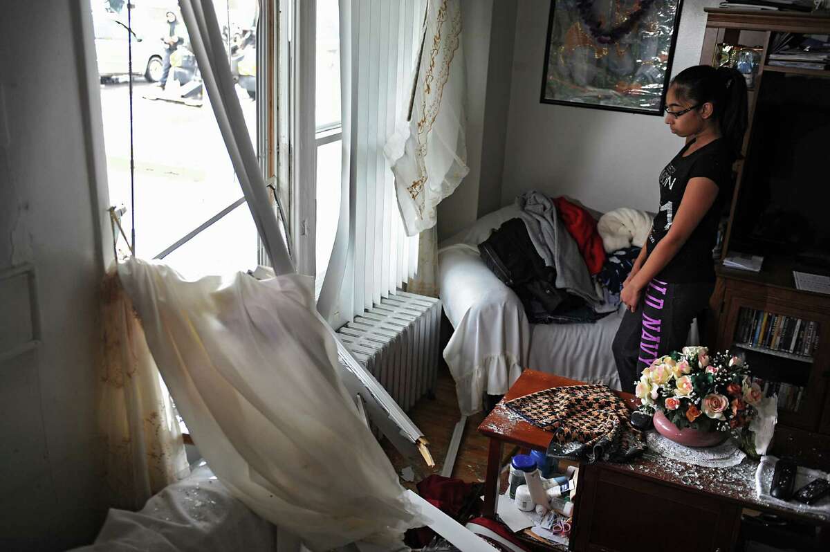 Crash into house injures occupant