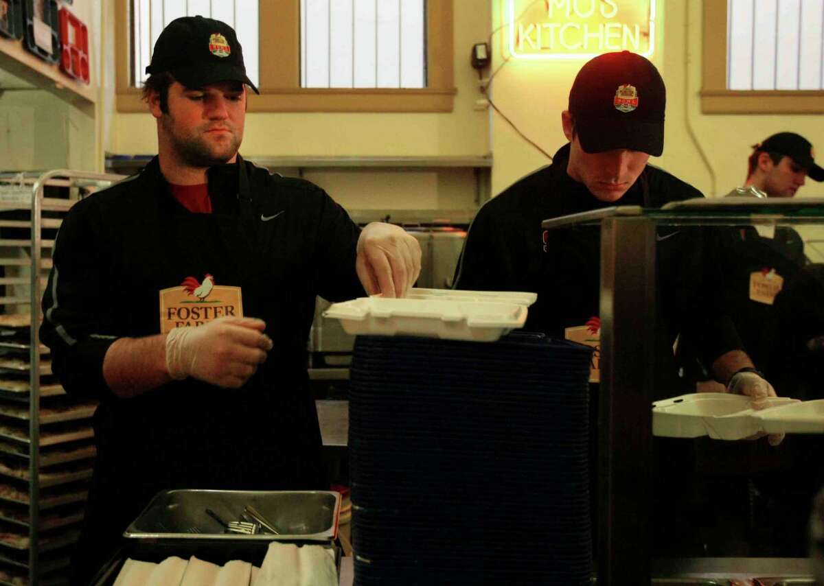 Stanford, Maryland football teams take time out to feed hungry