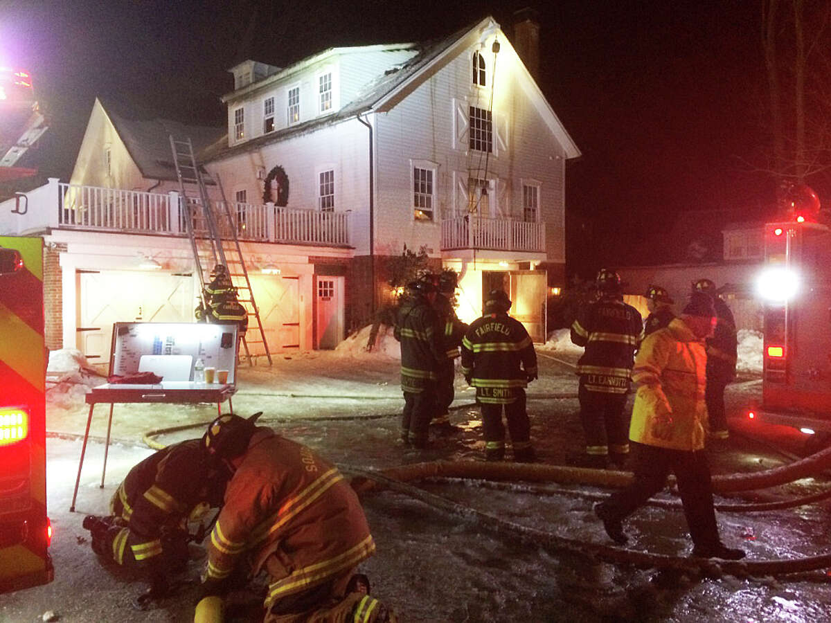 Firefighters battle flames, frigid weather at Southport home's roof fire