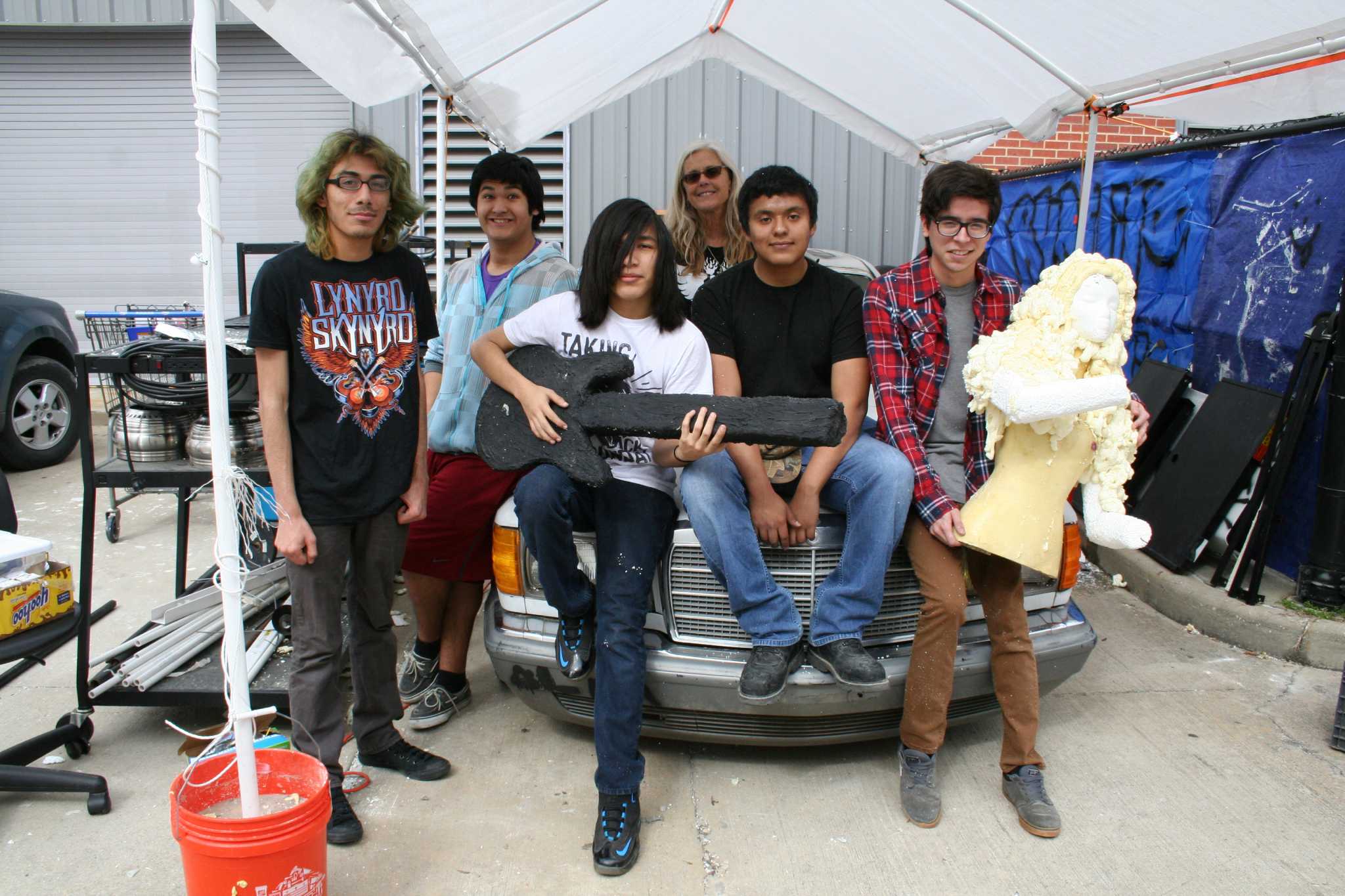 Teens delight in turning old car into rock 'n' roll art on wheels