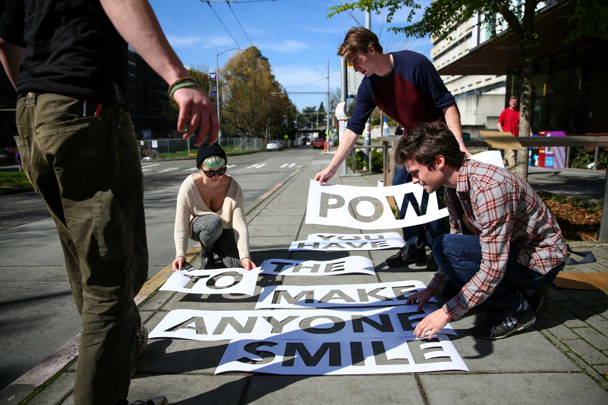 Rain-activated art brings smiles to people on the sidewalks of Seattle