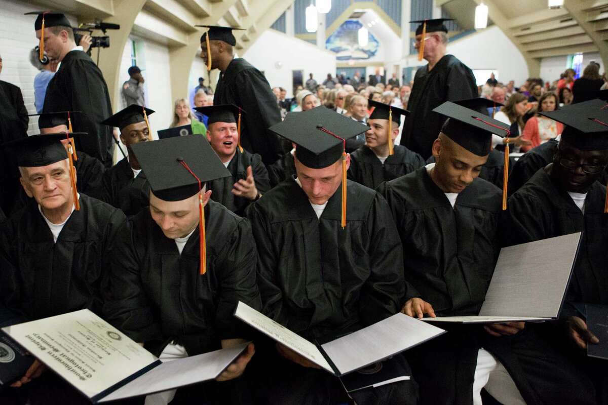 Gowns cover prison whites as first class of Darrington seminarians graduate