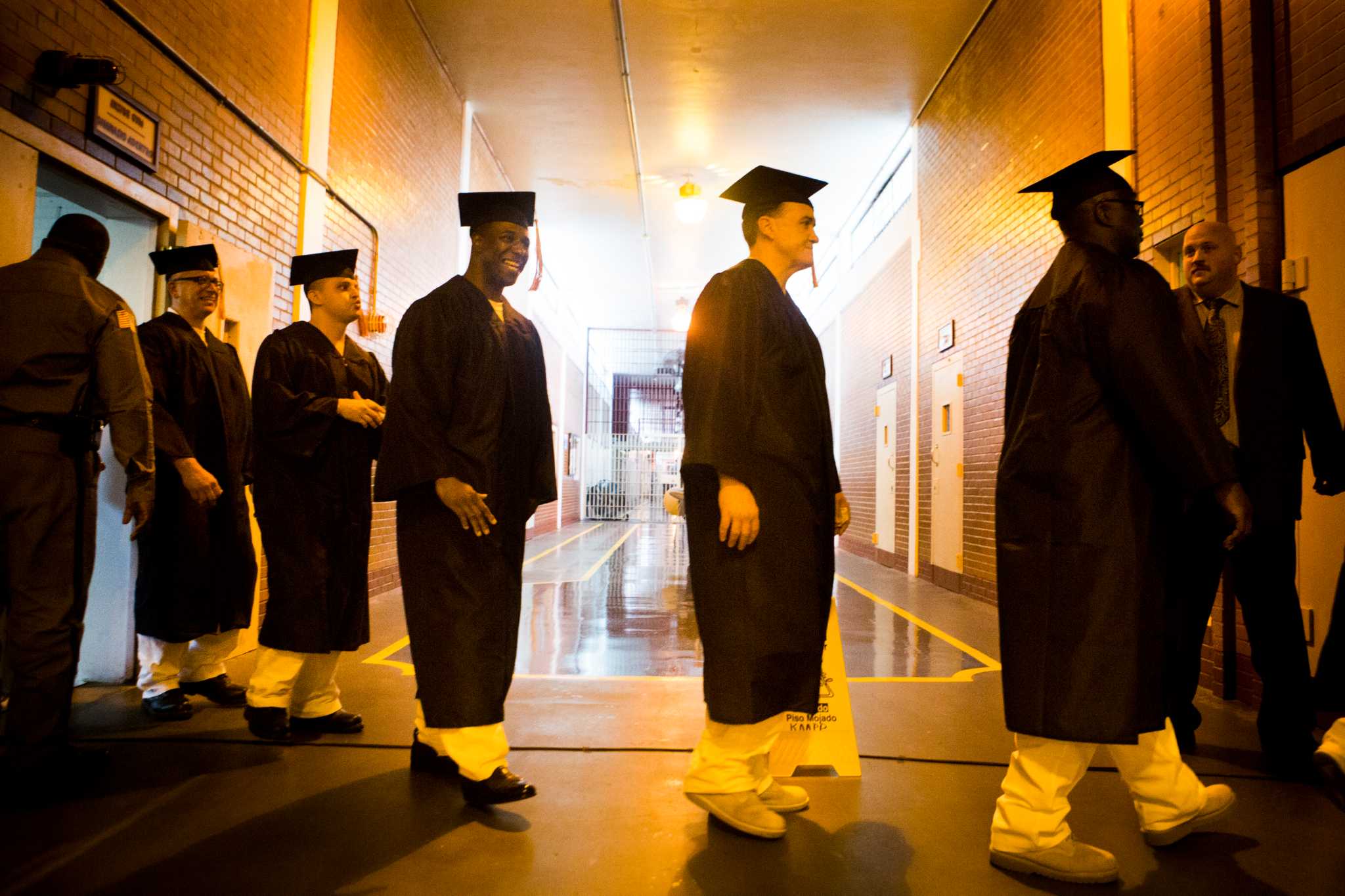 Gowns cover prison whites as first class of Darrington seminarians graduate