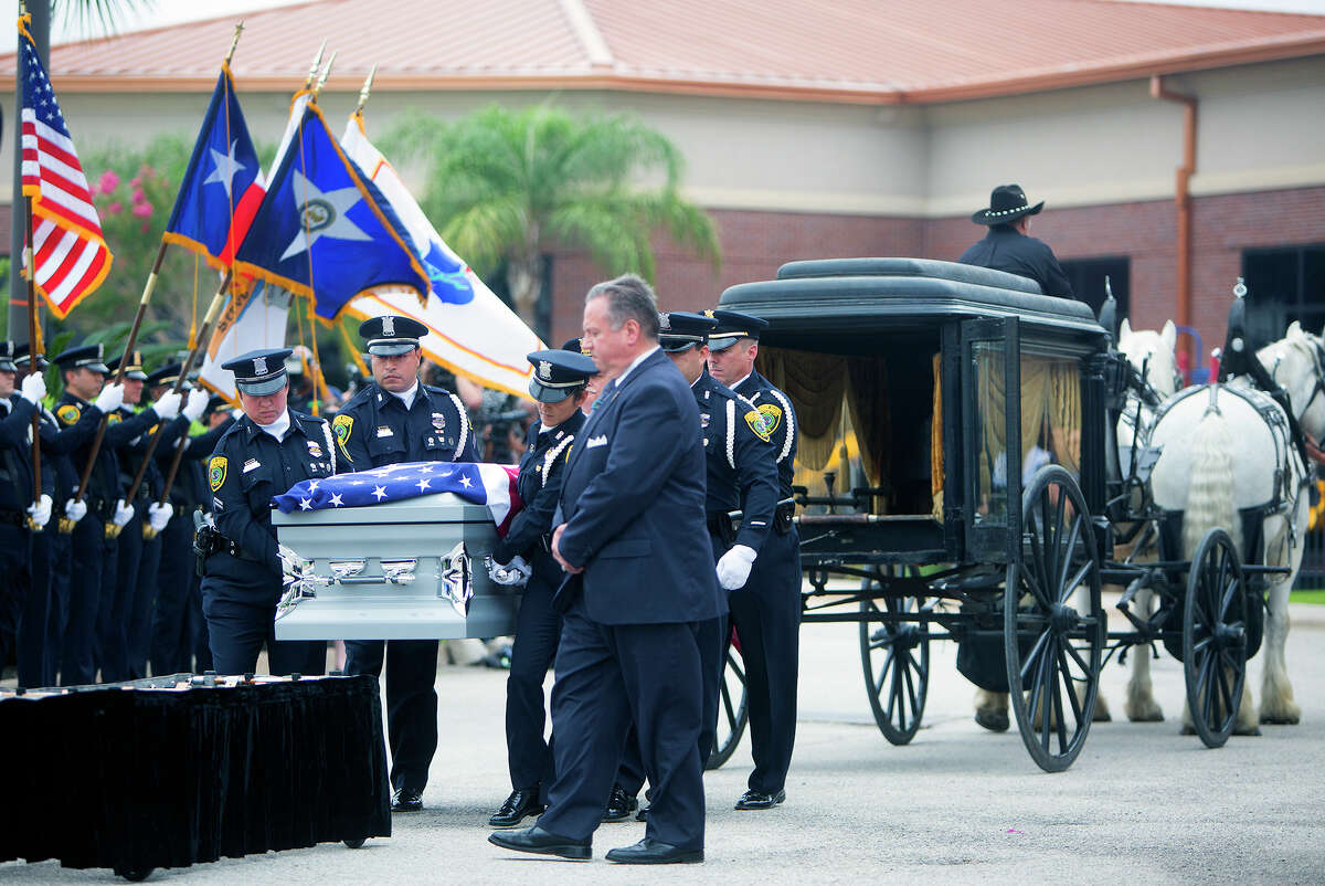 At policeman's funeral, young son makes a pledge