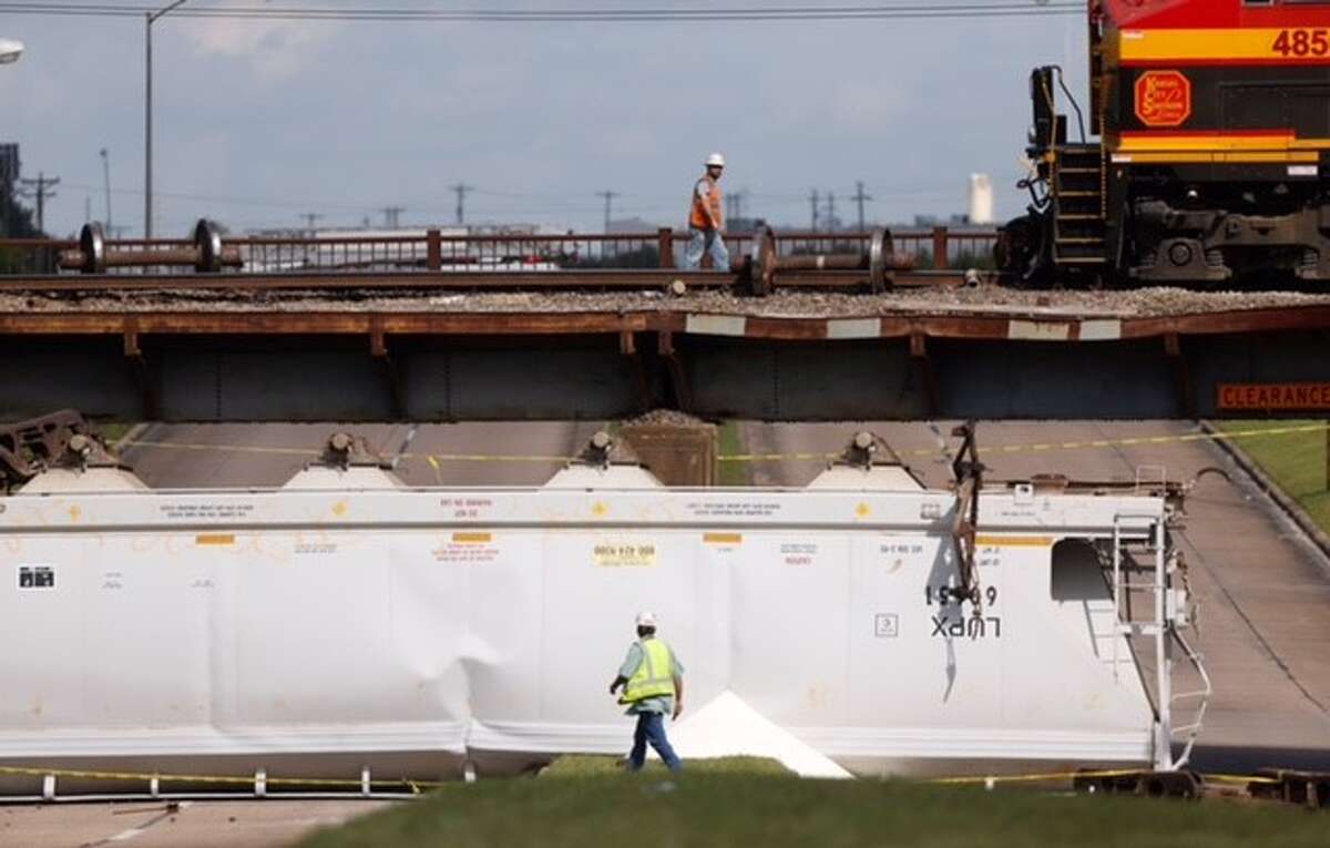 Railcar plunges from overpass to street below
