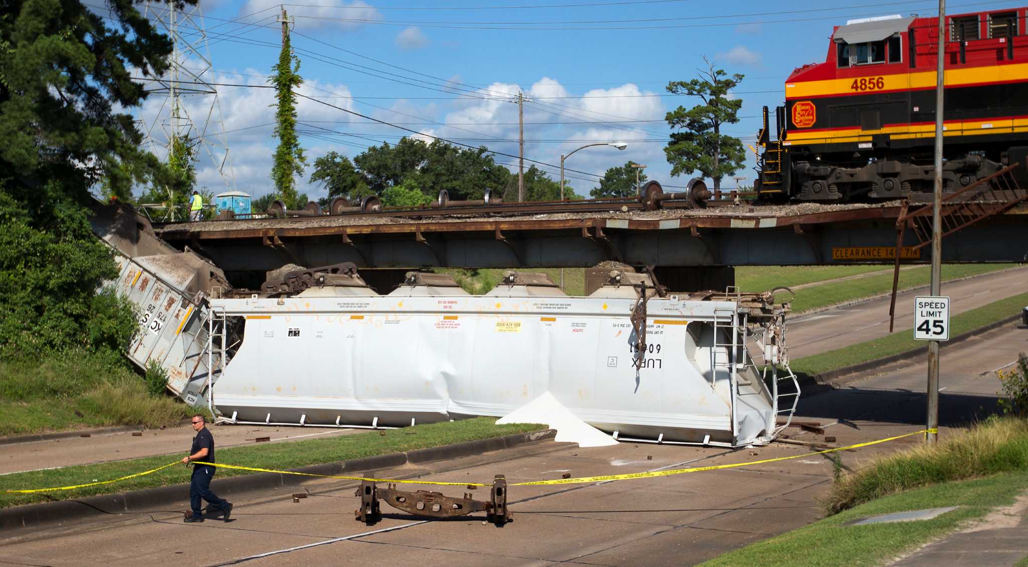 Railcar plunges from overpass to street below