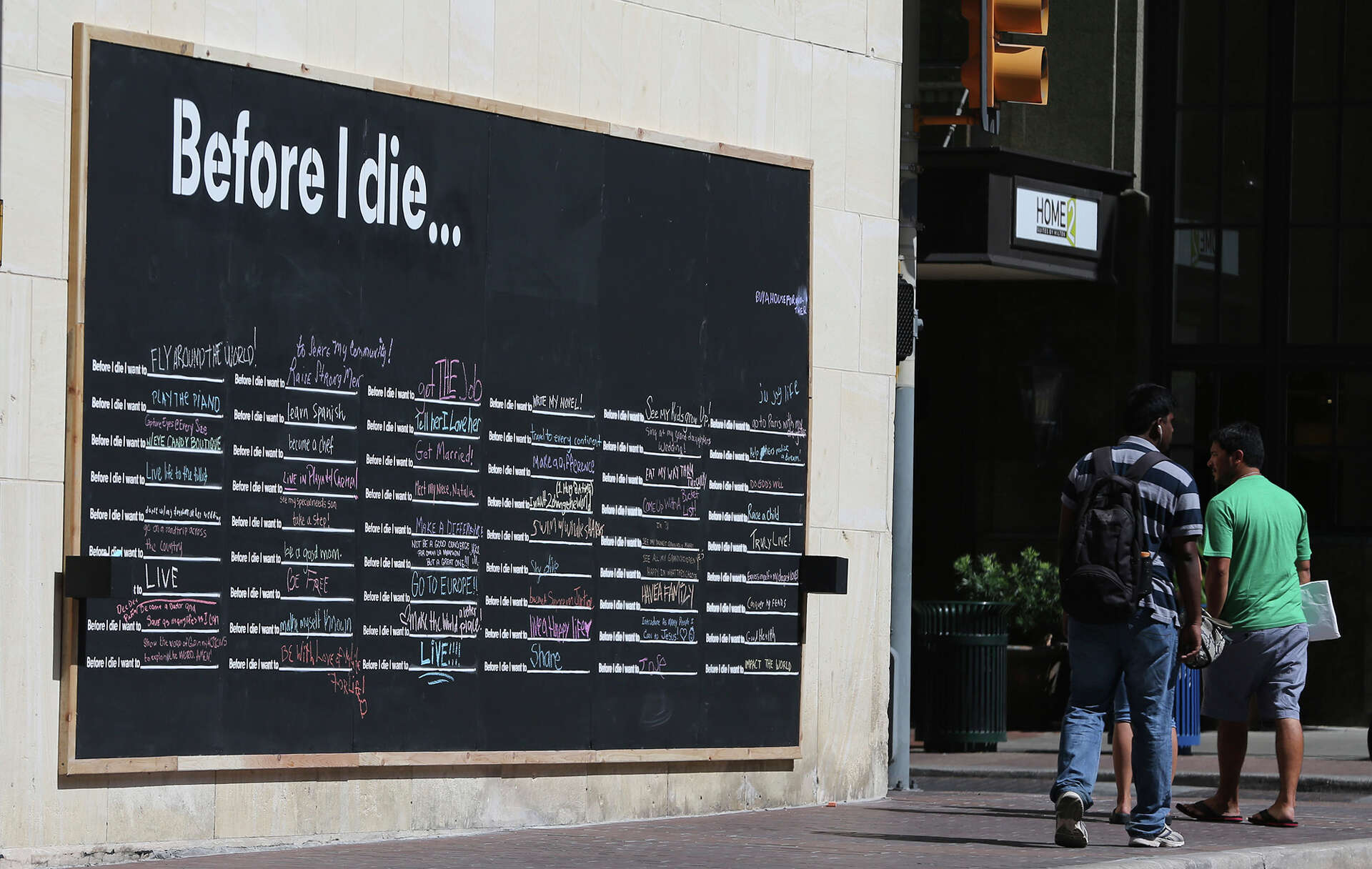 Downtown visitors write wishes on public chalkboard