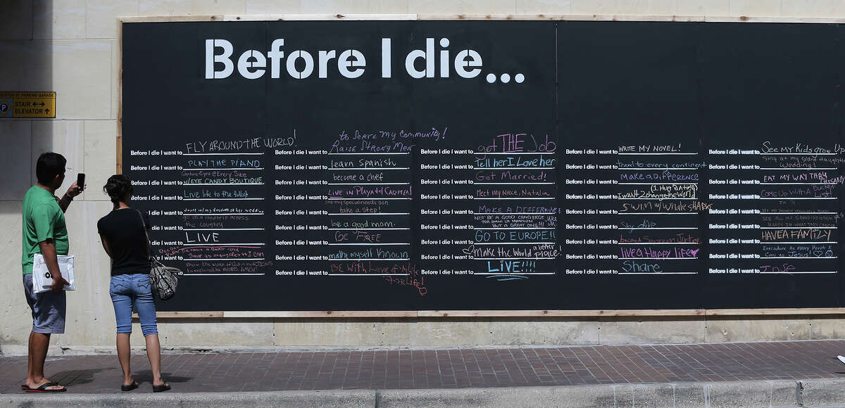 Downtown visitors write wishes on public chalkboard