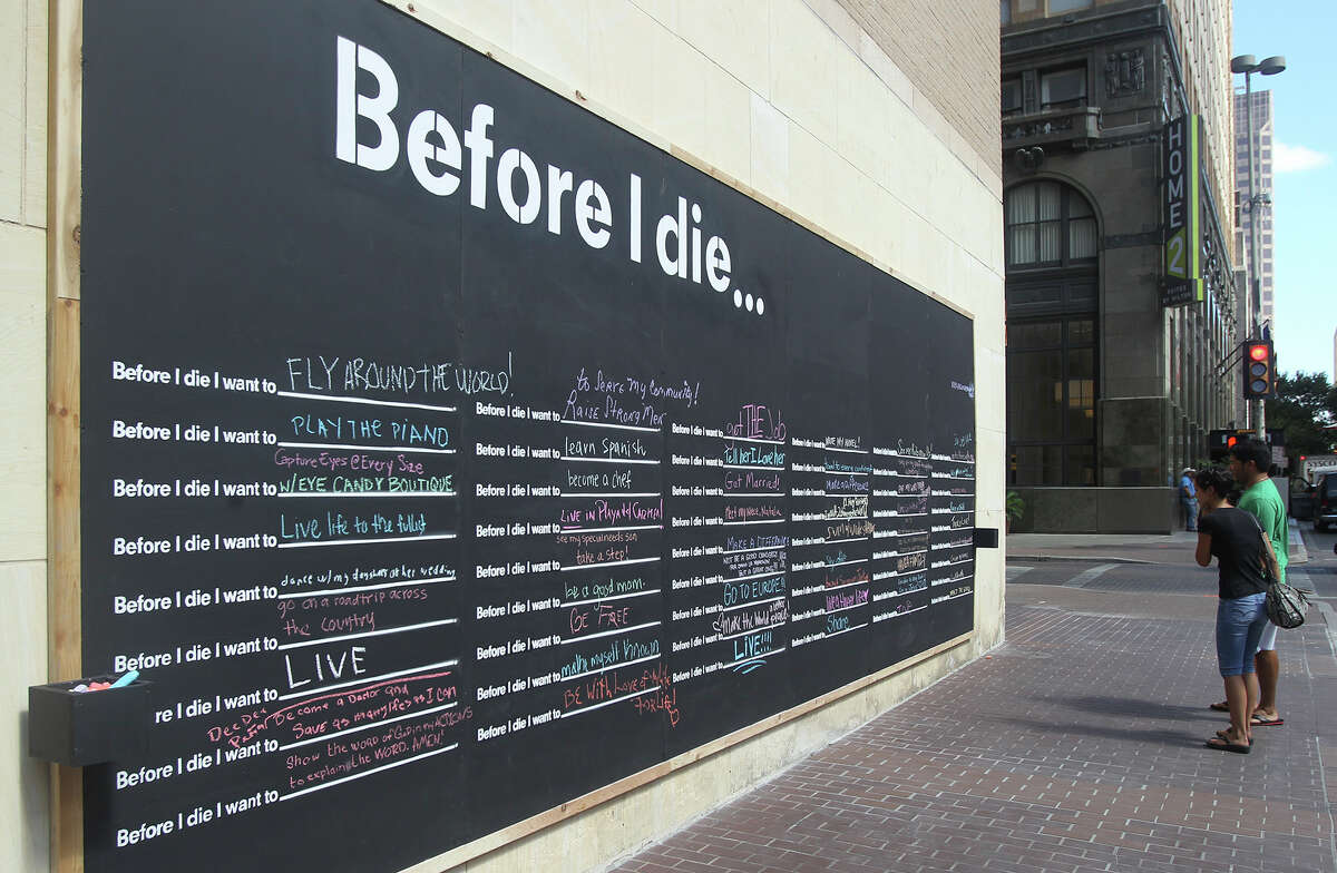 Downtown visitors write wishes on public chalkboard