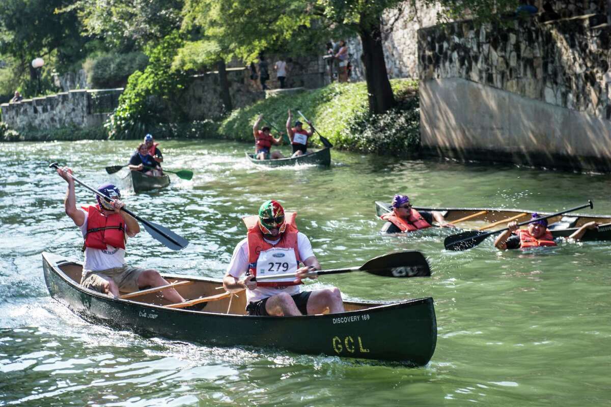 Paddling, sinking, smiling mark canoe races on River Walk