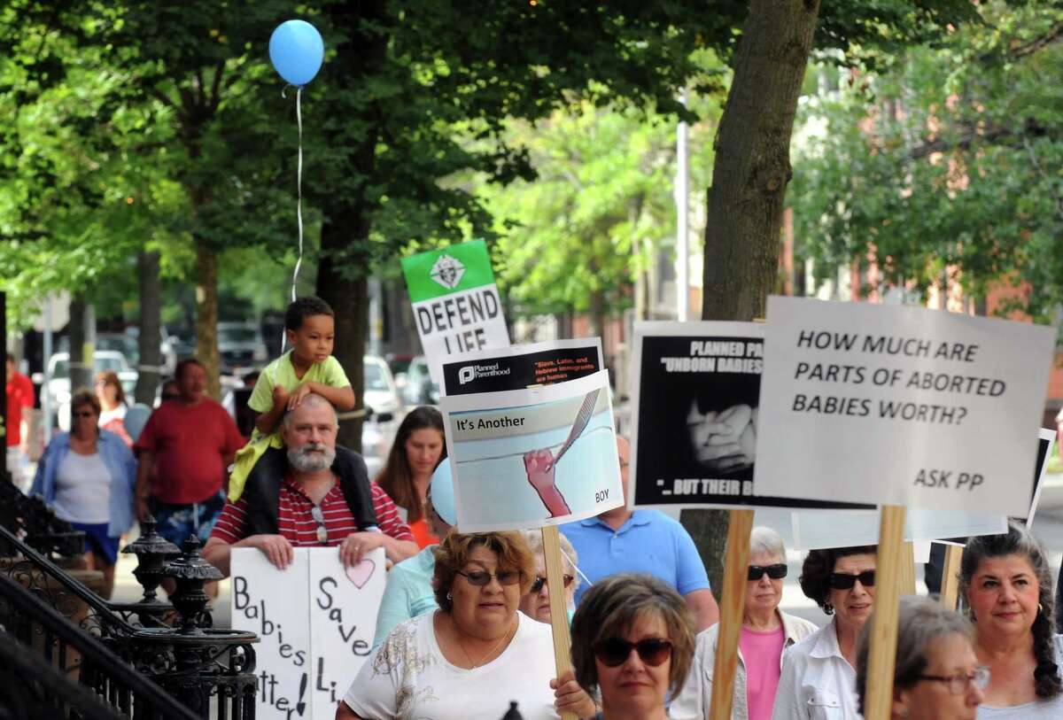 Demonstrators march against Planned Parenthood in Troy