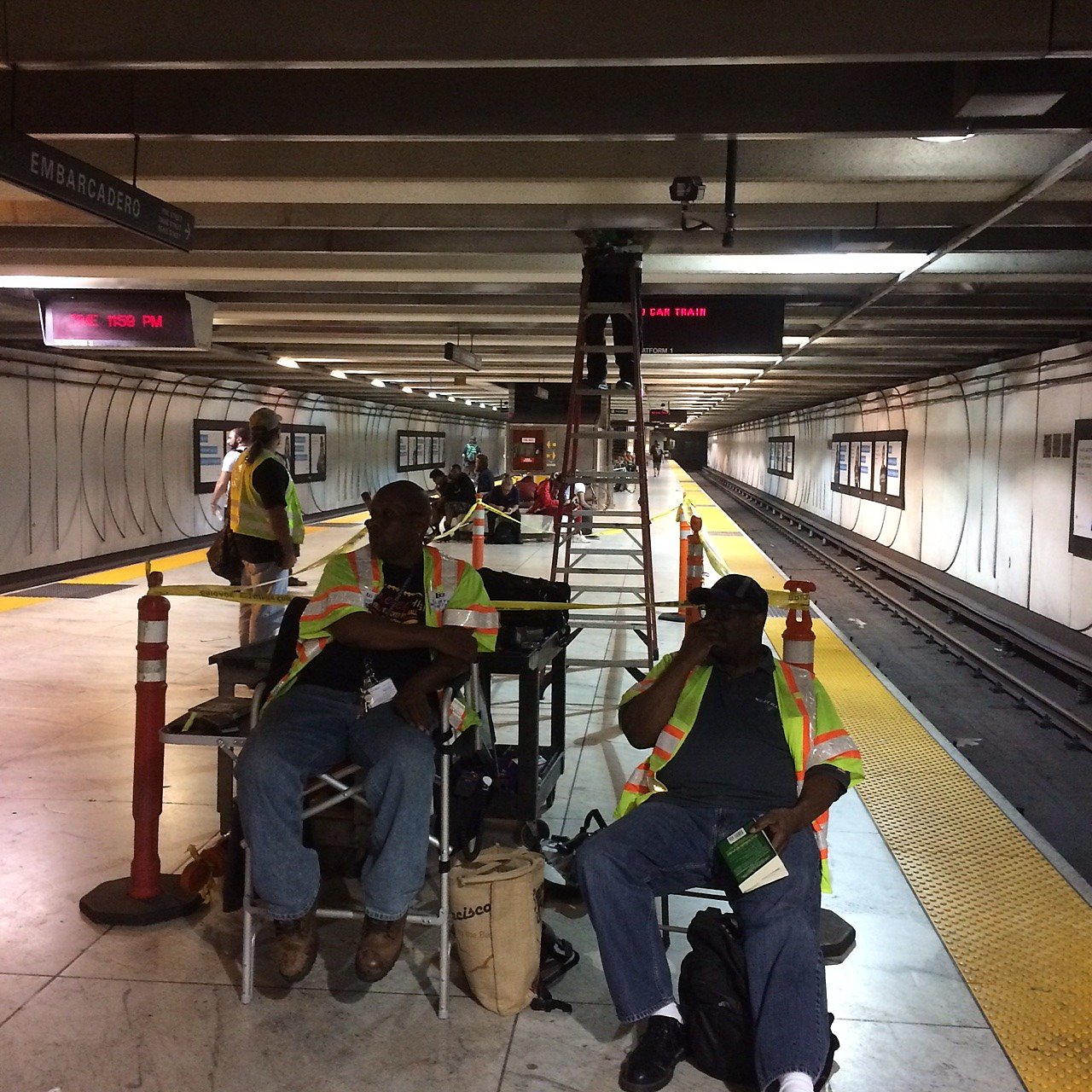 BART rider photographs safety monitors sitting down on the job
