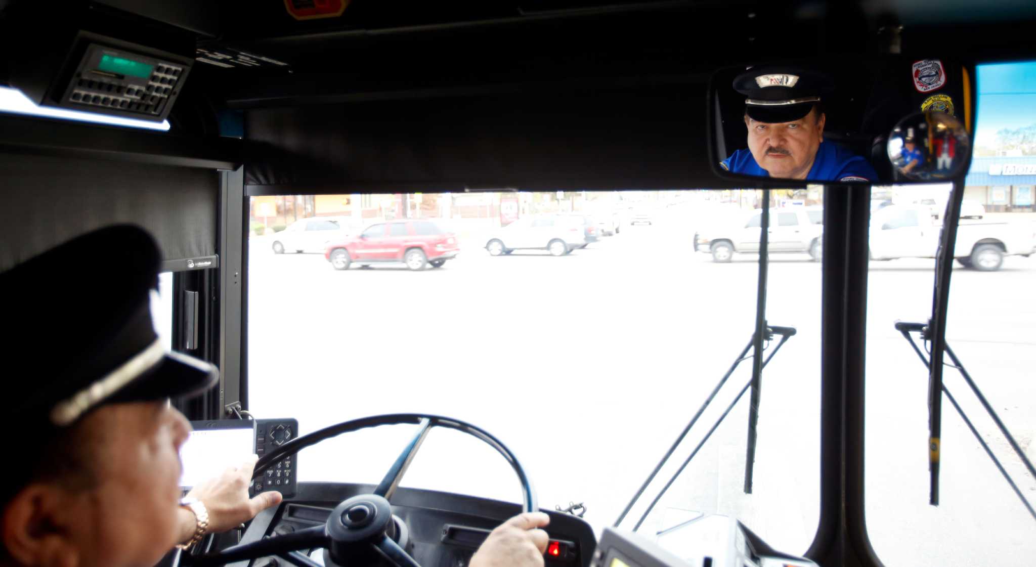 Local bus driver navigates roads, passengers