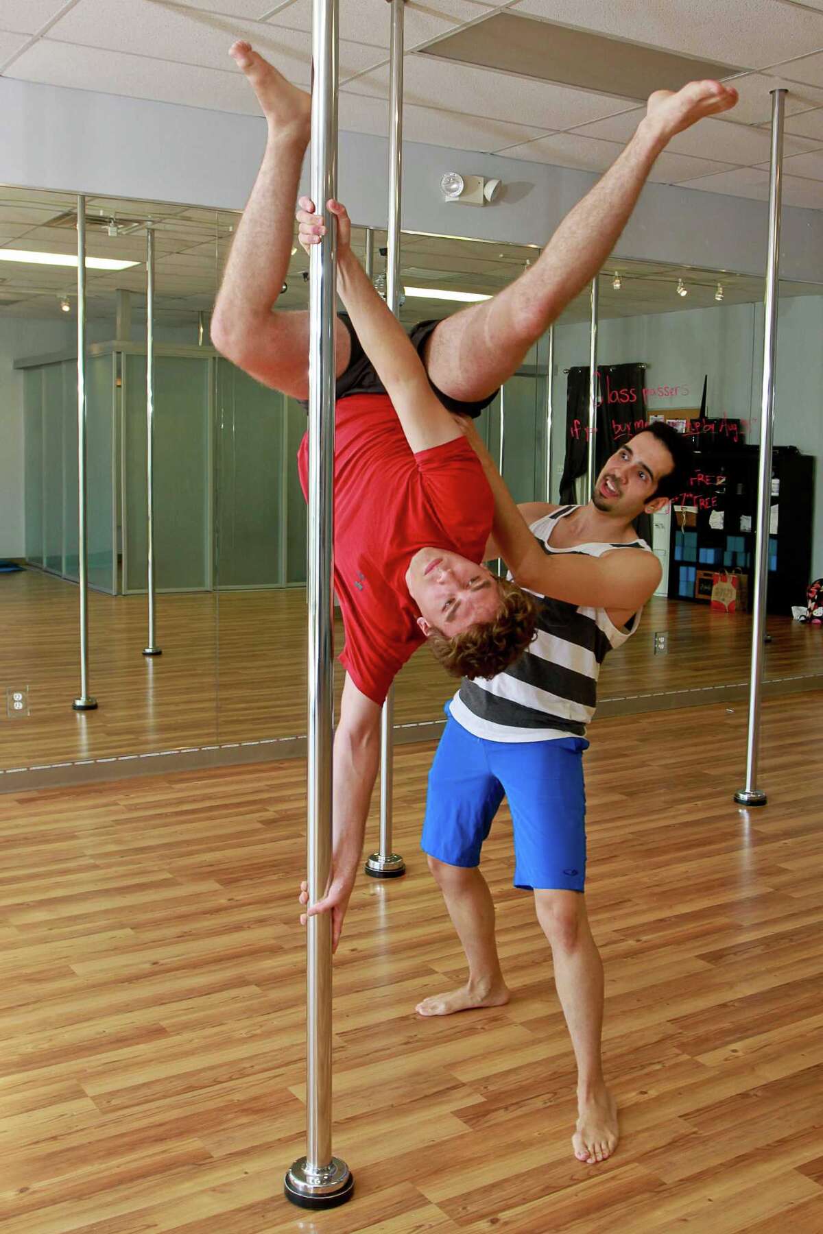 Men seeking workout challenge take pole-dancing class for a spin