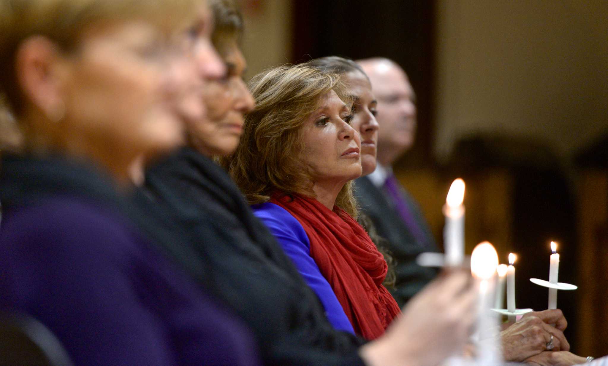 Flowers and flame for victims of abuse at the Greenwich Y