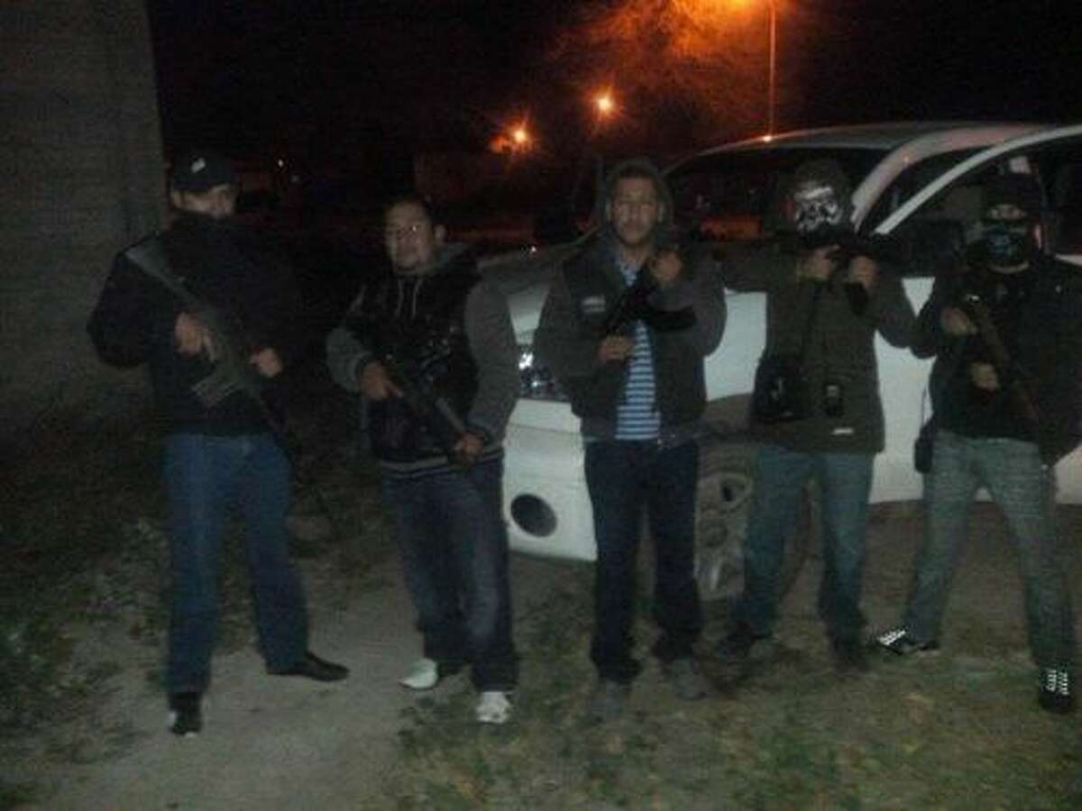 Photos leaked of La Linea cartel members holding guns, showing off trucks