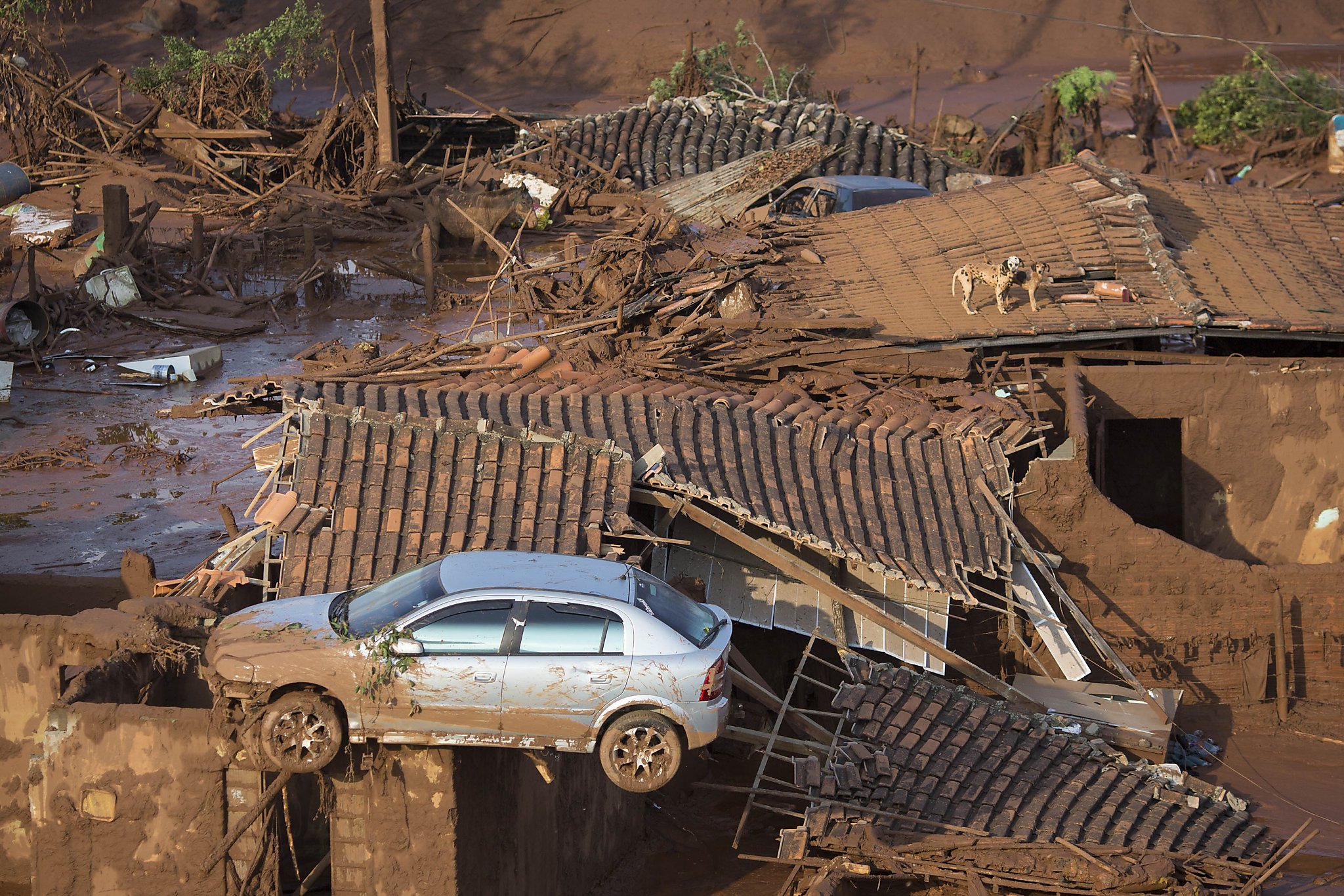Mine dams burst in Brazil; 2 dead, homes covered in mud
