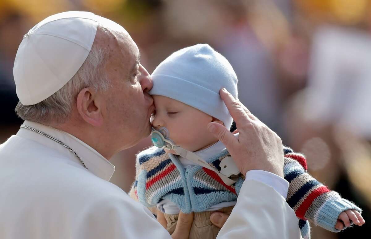Pope Francis kisses babies