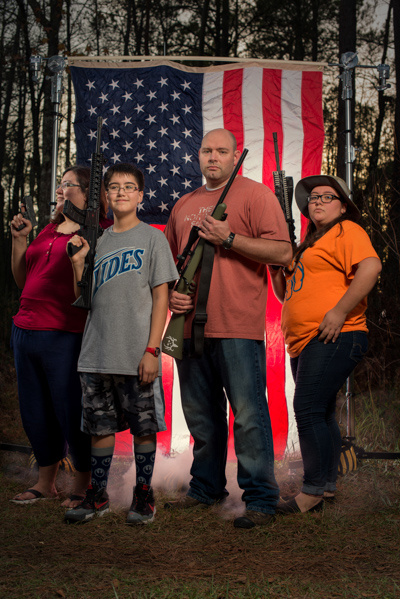 Gun owners pose with their Christmas presents in gun range photo series