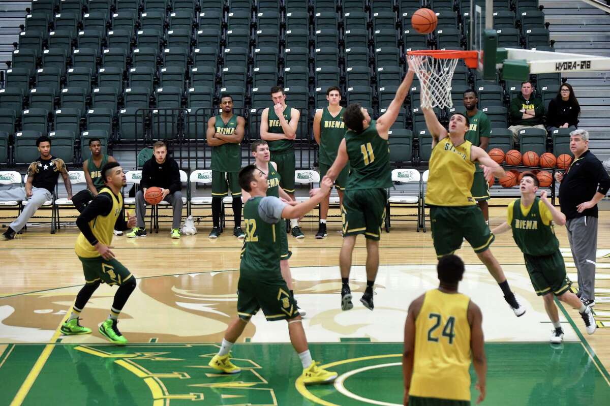 For college basketball's benchwarmers, hard work and little fanfare