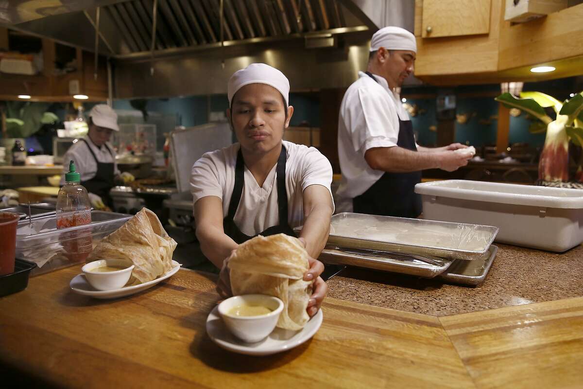 Making roti canai, a flaky Malaysian flatbread, is a spectacle