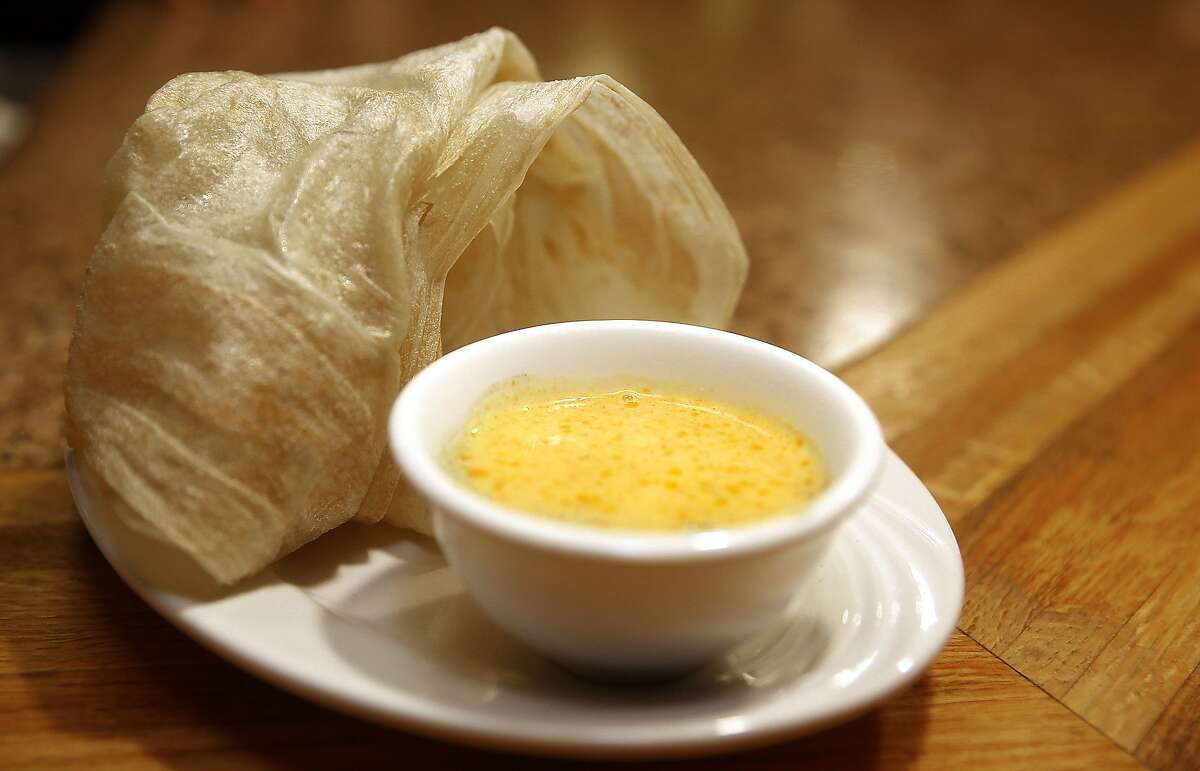 Making roti canai, a flaky Malaysian flatbread, is a spectacle