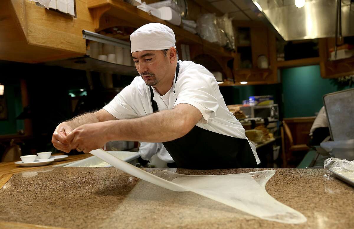 Making roti canai, a flaky Malaysian flatbread, is a spectacle