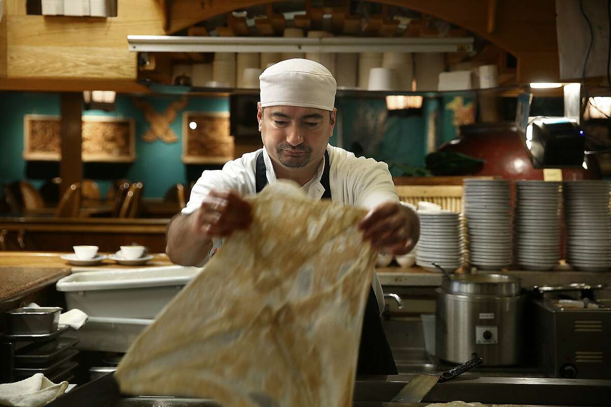 Making roti canai, a flaky Malaysian flatbread, is a spectacle