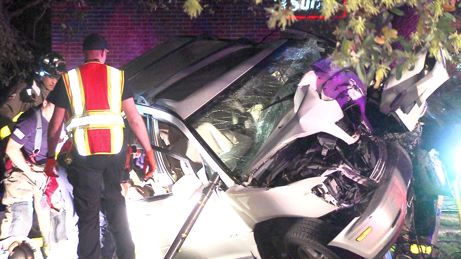 Firefighters cut woman from SUV after she crashed into tree on North Side