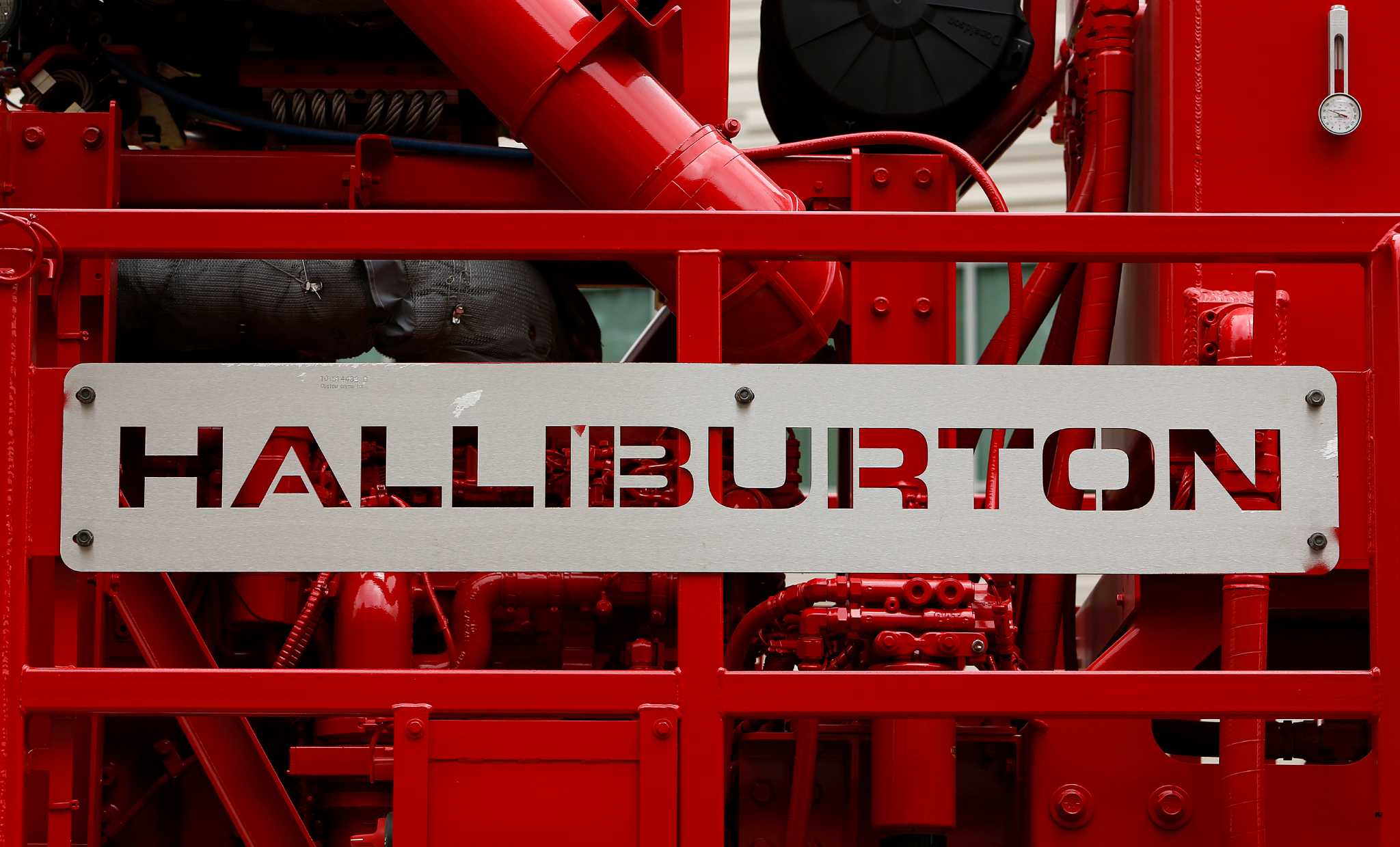 Halliburton cutting benefits, exec bonuses