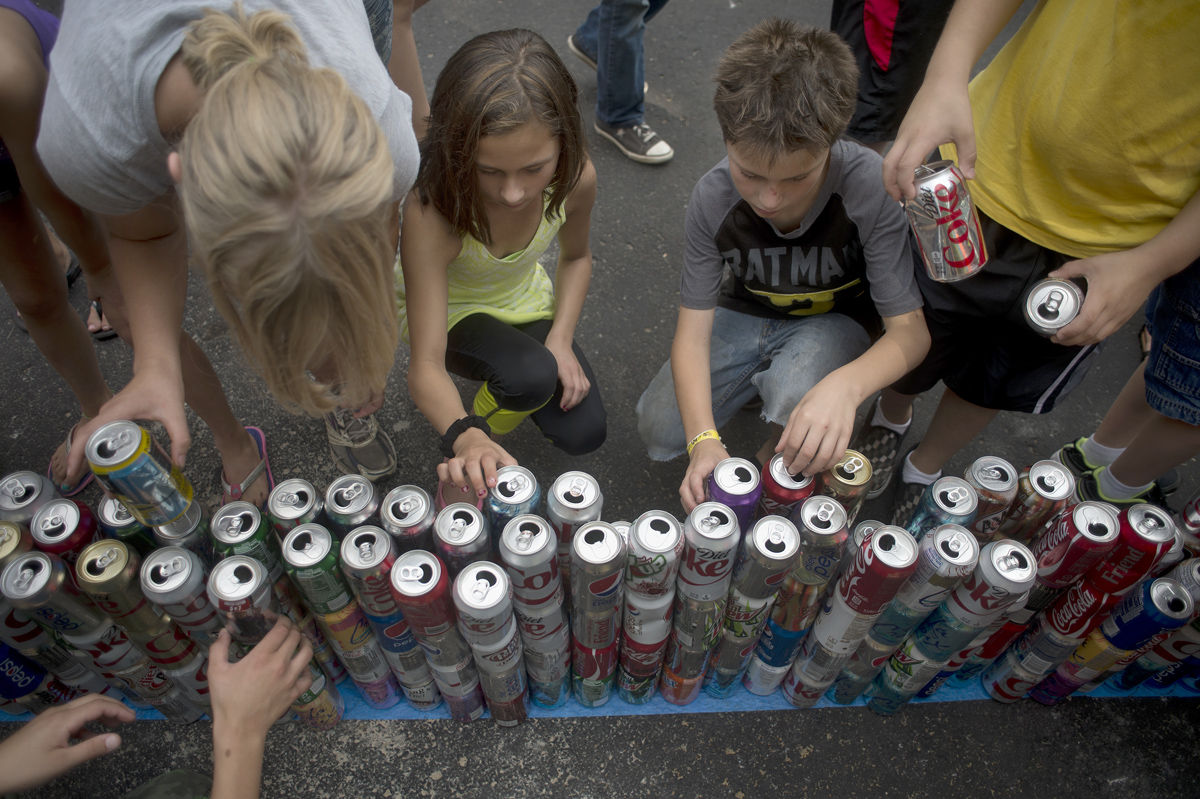 Dow COP students build pop can wall at West Midland Family Center