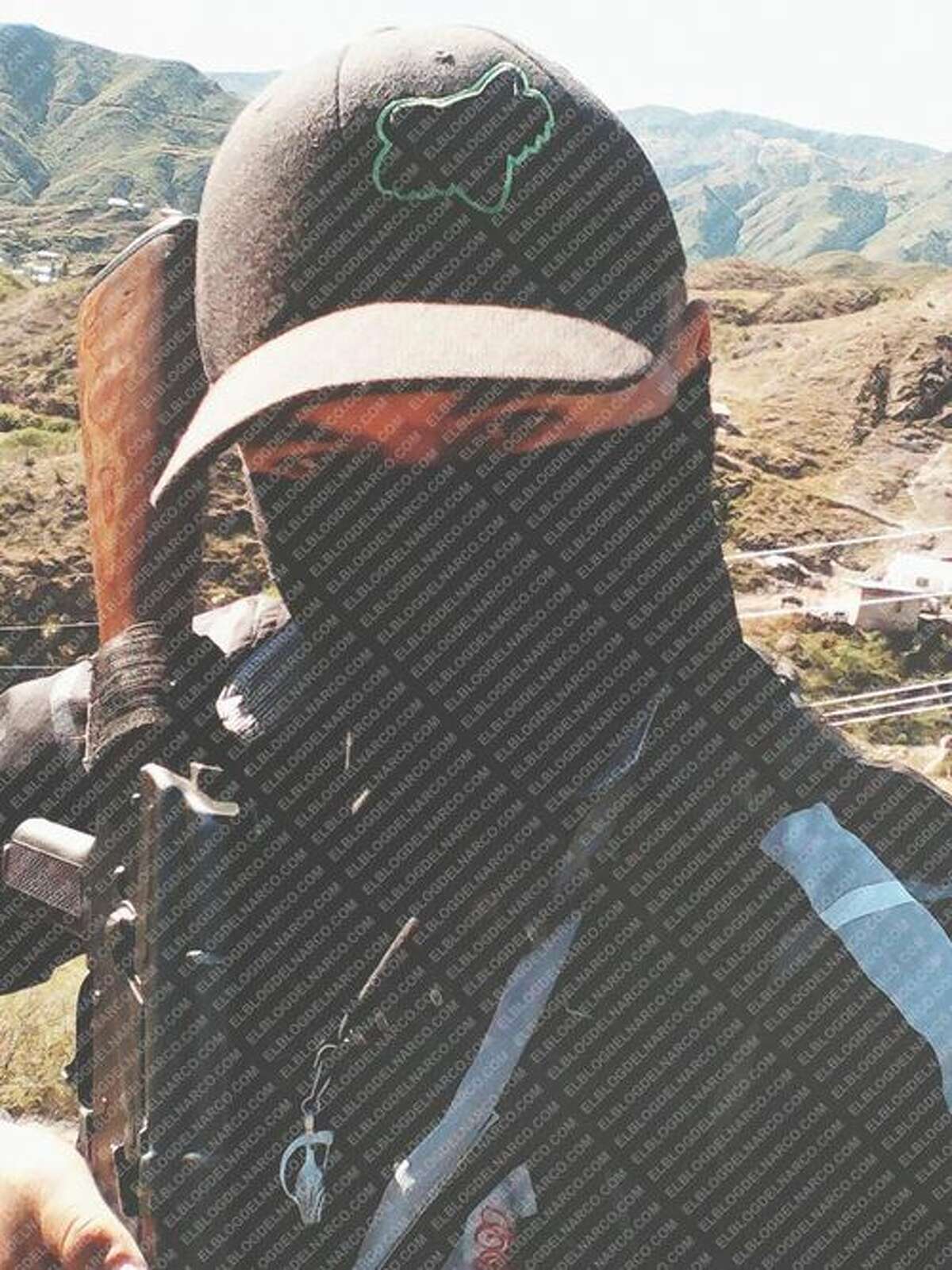 Masked assassins for the Juárez Cartel in Mexico shown holding guns in ...