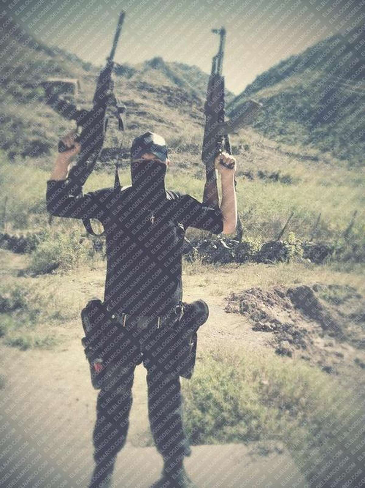 Masked assassins for the Juárez Cartel in Mexico shown holding guns in ...