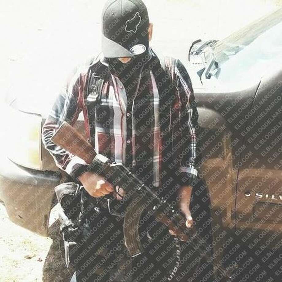 Masked assassins for the Juárez Cartel in Mexico shown holding guns in ...