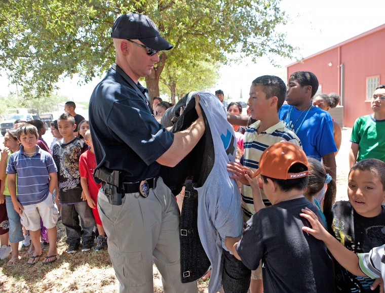 Children watch K-9 demonstration at police academy