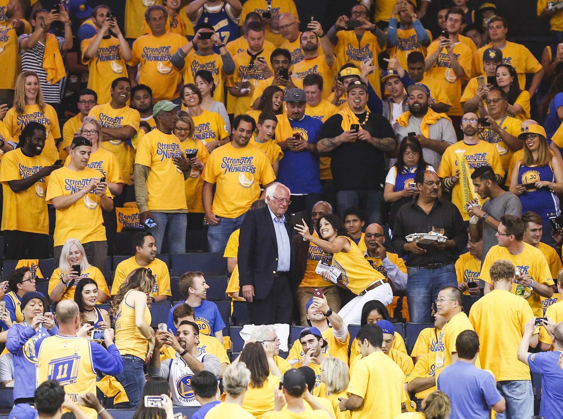 Presidential candidate Bernie Sanders arrives at halftime